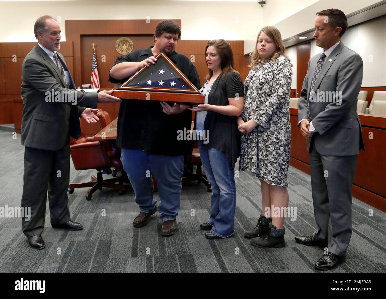U.S. Marshals John Garrison, left, and Richard Taylor, right, present a ...