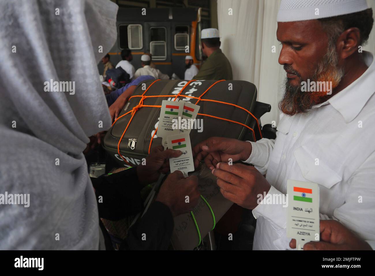 An Indian Hajj pilgrim, left, prepares to leave for the holy city of ...