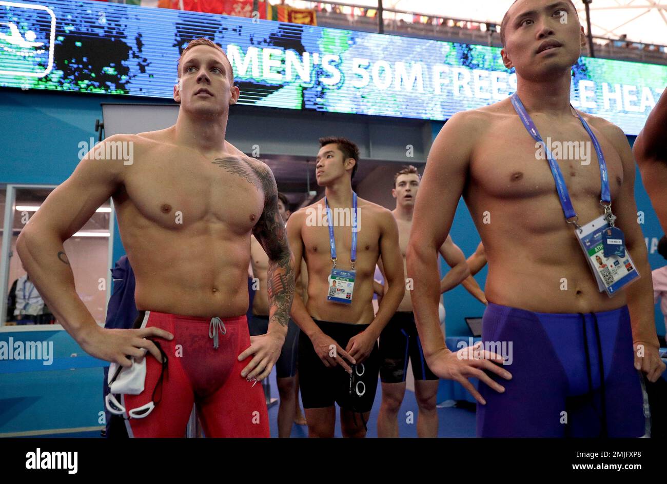 United States' Caeleb Dressel, left, leaves the pool after his heat of ...