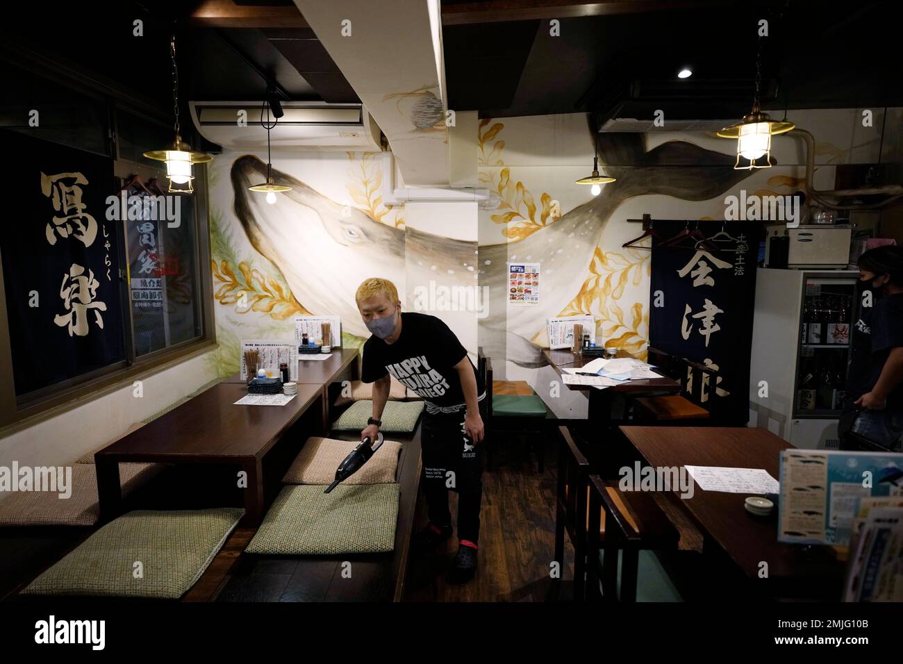 A staff of the Japanese restaurant "Kujira no Ibukuro" that serves ...