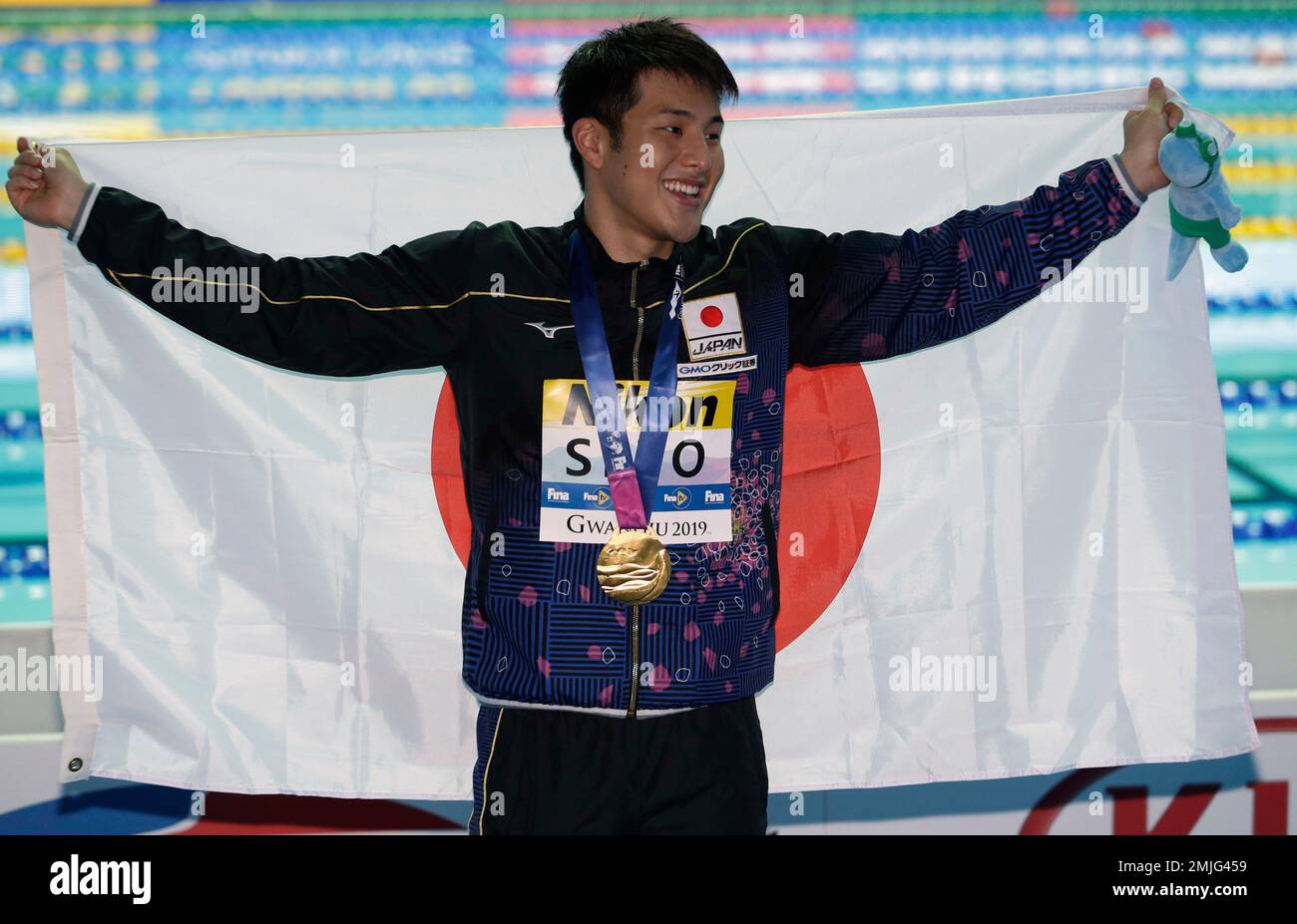 Gold medalist Japan's Daiya Seto poses with his national flag after ...
