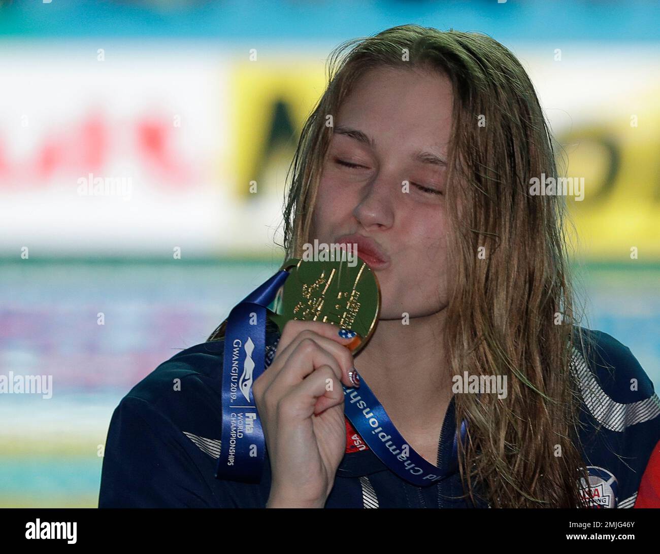 Gold medalist United States' Olivia Smoliga kisses her medal following ...
