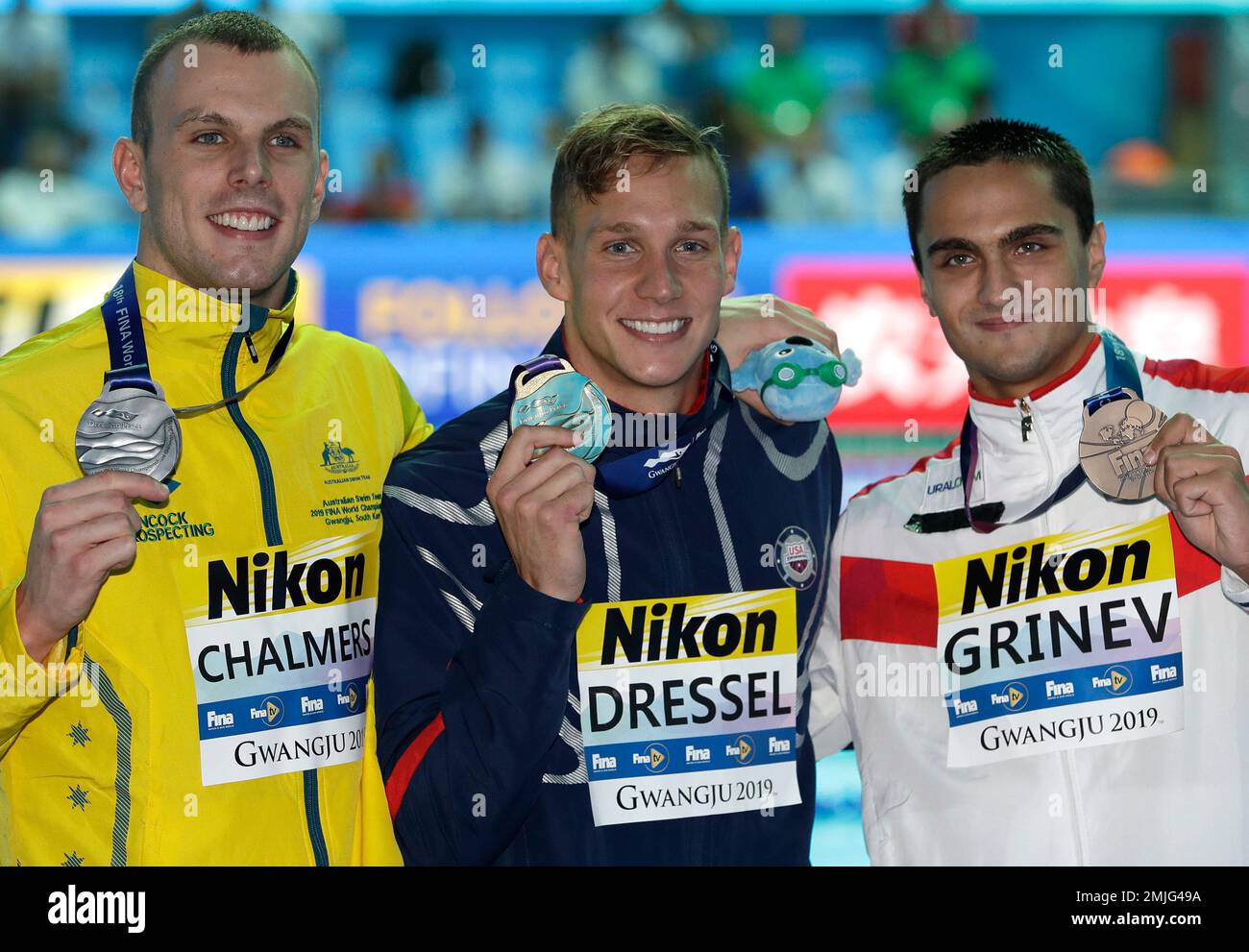 Gold medalist United States' Caeleb Dressel, centre, stands with silver ...