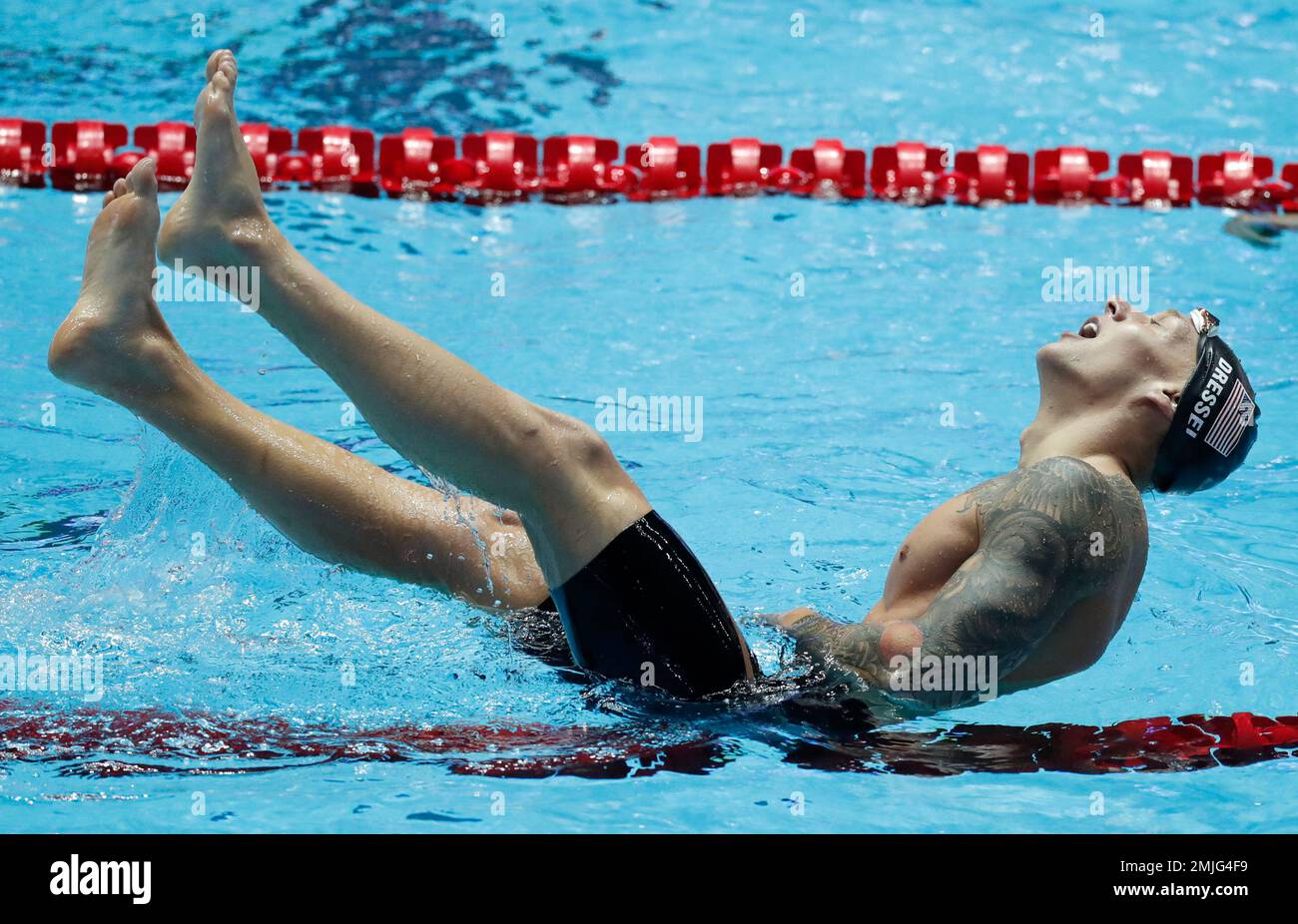 United States' Caeleb Dressel celebrates after winning the men's 100m ...