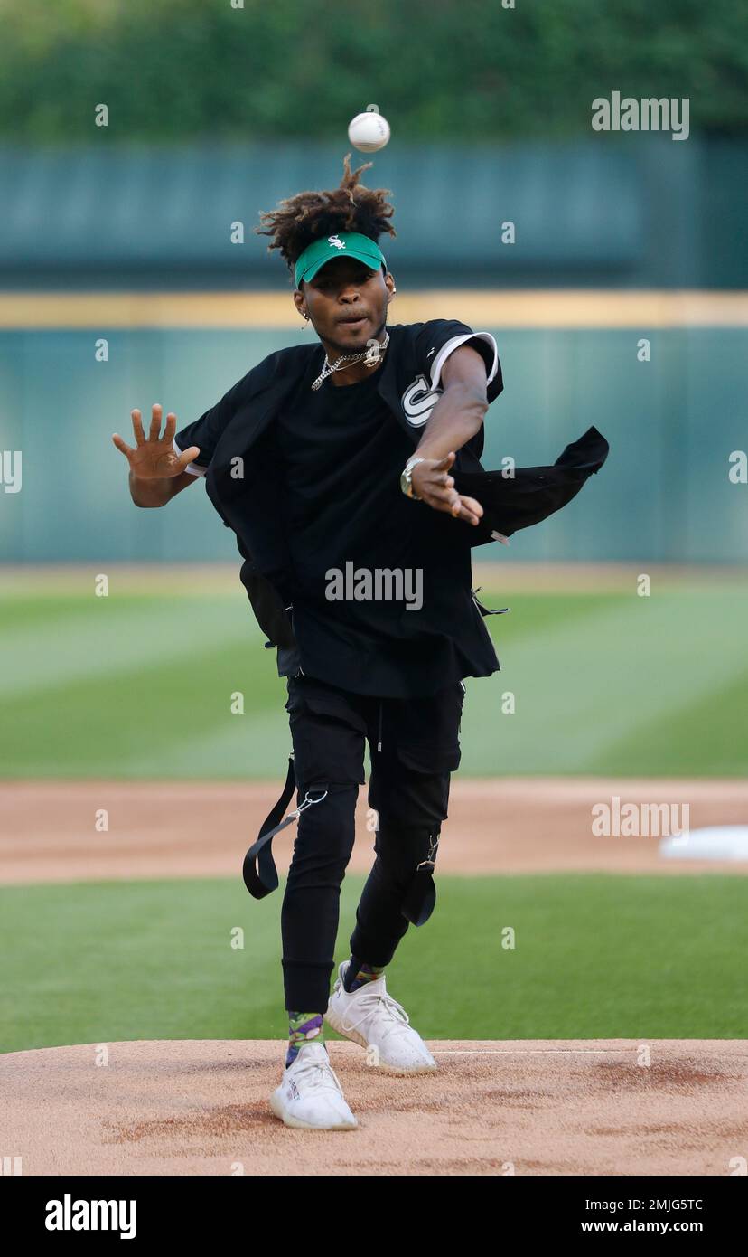 Magician Jibrizy Taylor throws out a ceremonial first pitch before a ...