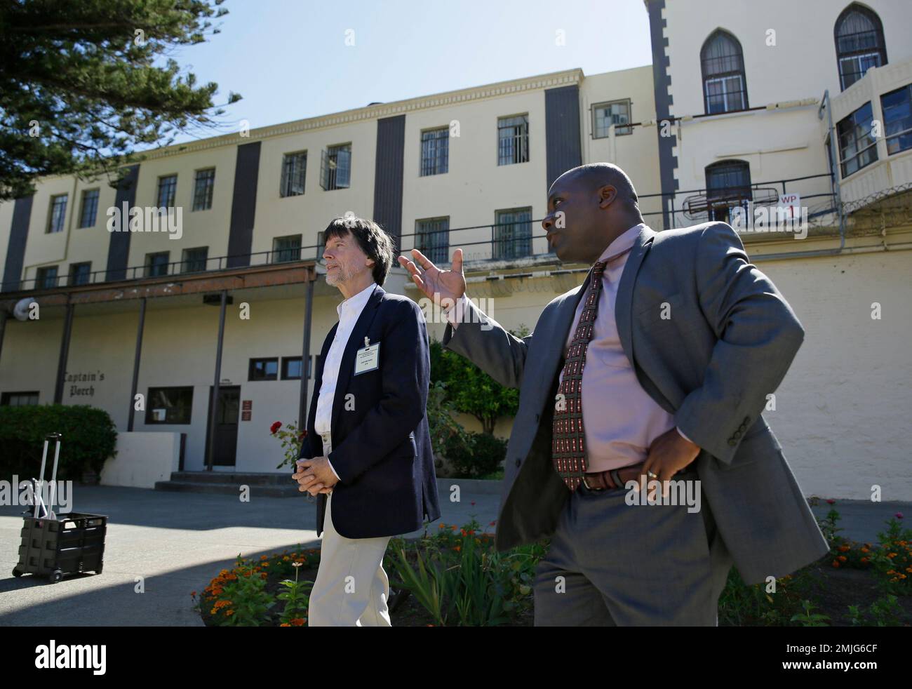 Filmmaker Ken Burns, left, is led into San Quentin State Prison by ...