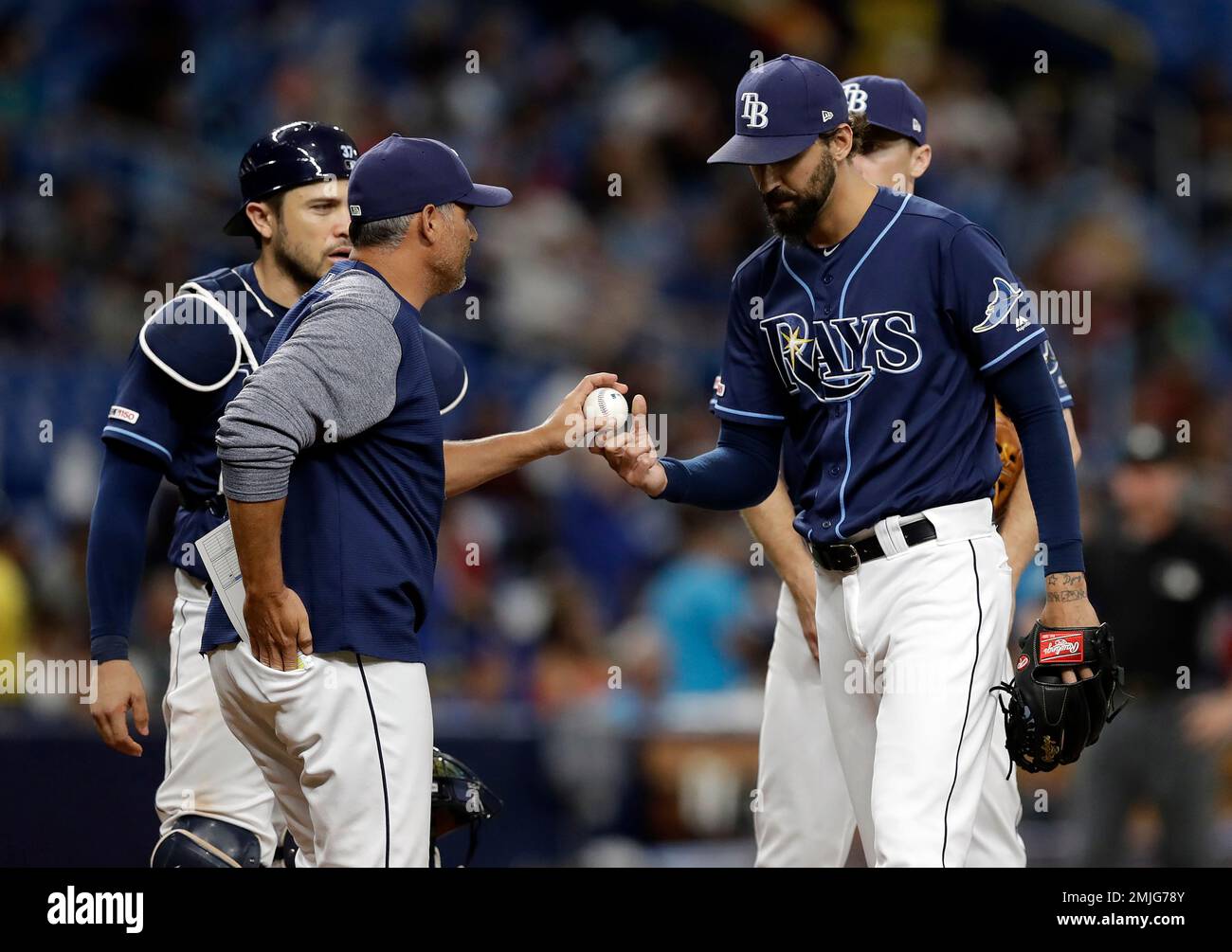 Tampa Bay Rays relief pitcher Chaz Roe , right, hands the ball to ...