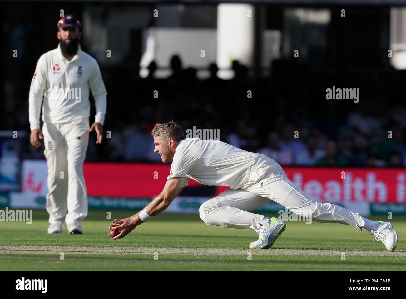England's Olly Stone makes a catch during the first day of the test ...