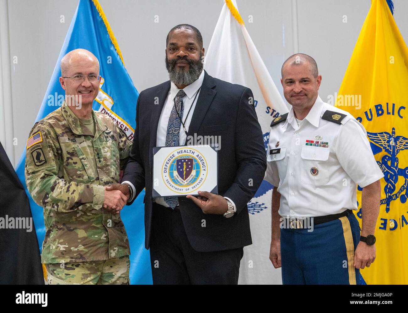 LTG Ronald J. Place, DHA Director, and SGM Isaac A. Bray, present the ...