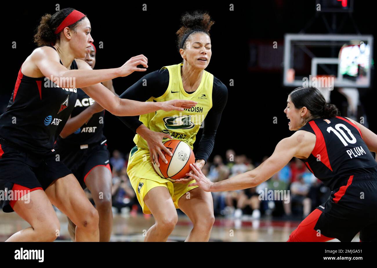 Seattle Storm's Alysha Clark, center, drives between Las Vegas Aces ...