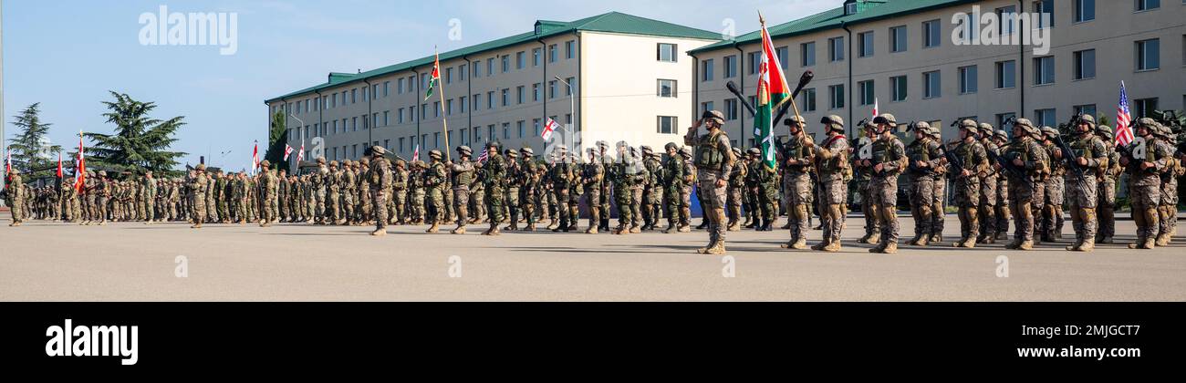 Multinational soldiers stand in formation during the opening ceremony ...