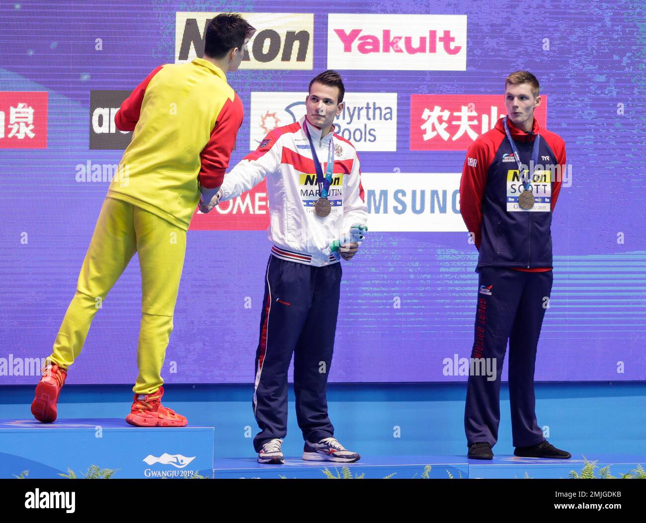 Britain's bronze medalist Duncan Scott, right, looks to gold medalist ...