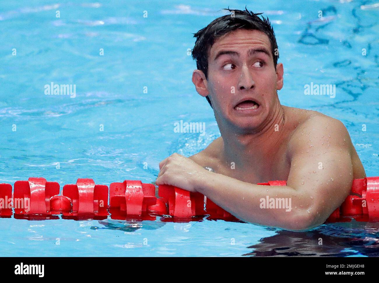United States' swimmer Justin Wright reacts following his heat of the ...