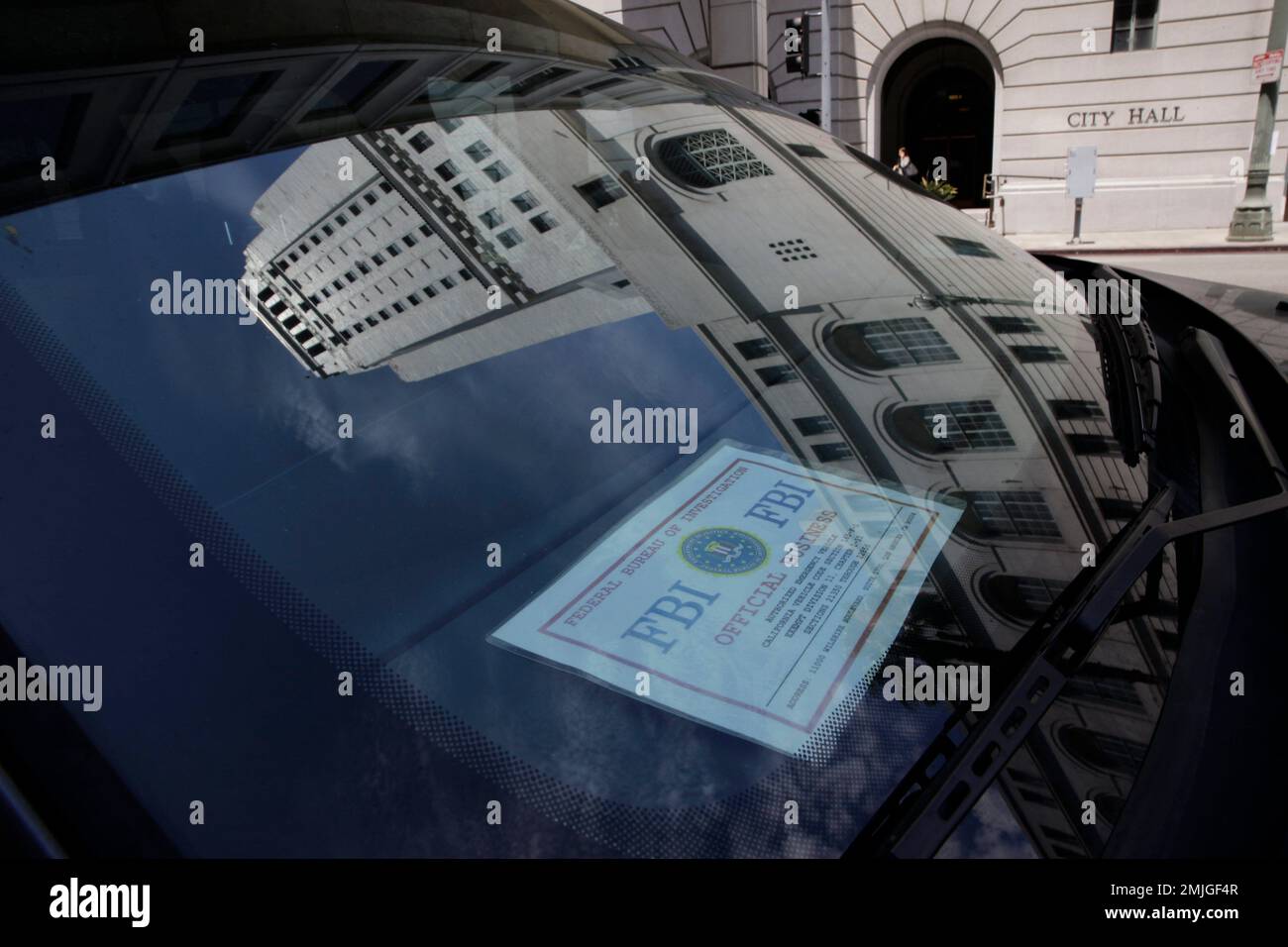 A van with an FBI placard inside is parked outside the Los Angeles City ...