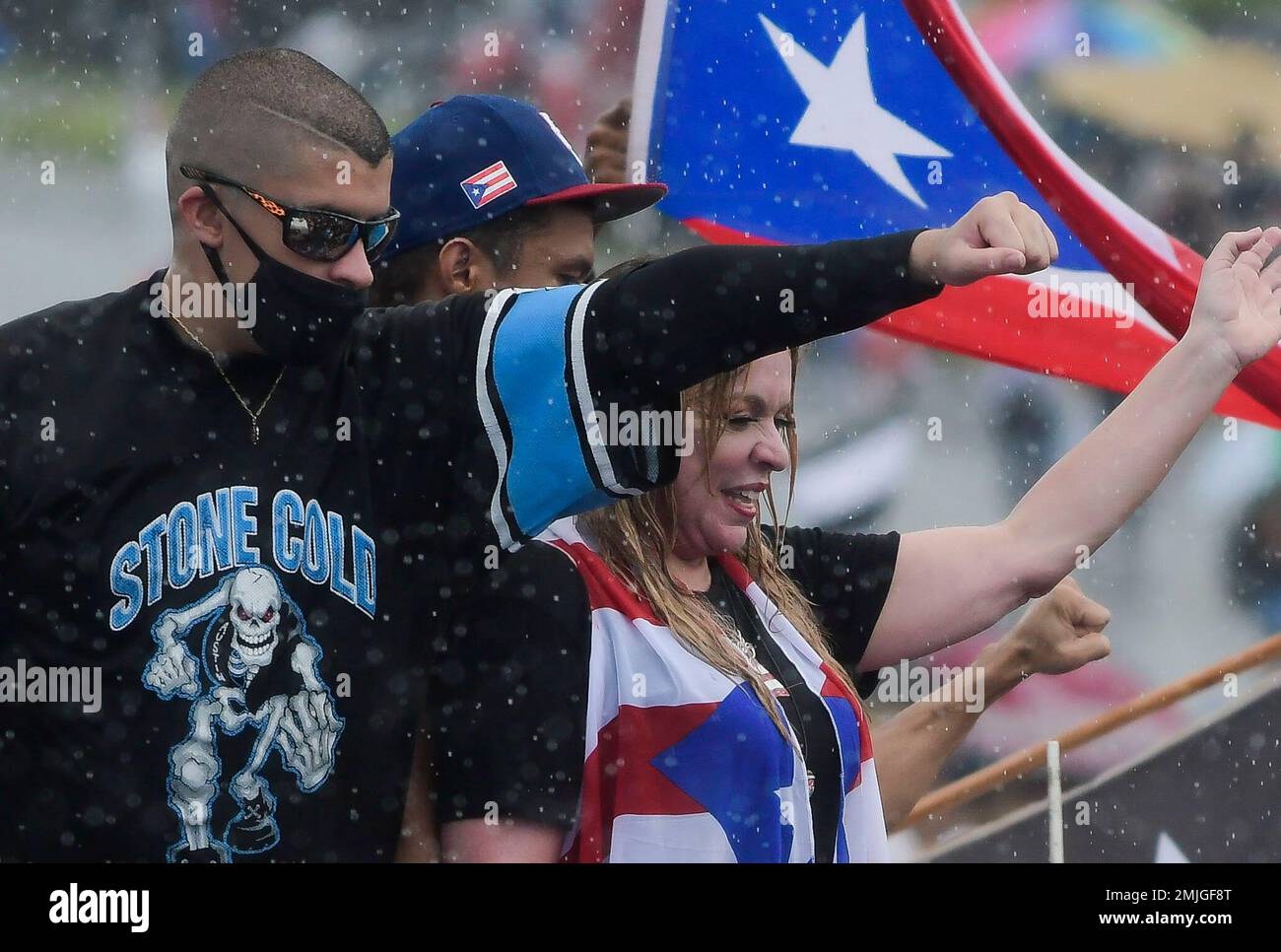 Puerto Rican rapper Bad Bunny, left, participates in a protest ...