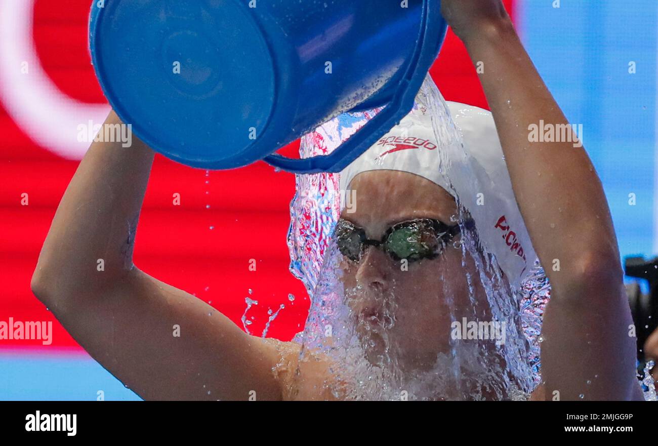Canada's Sydney Pickrem pours water over herself ahead of her swim in ...