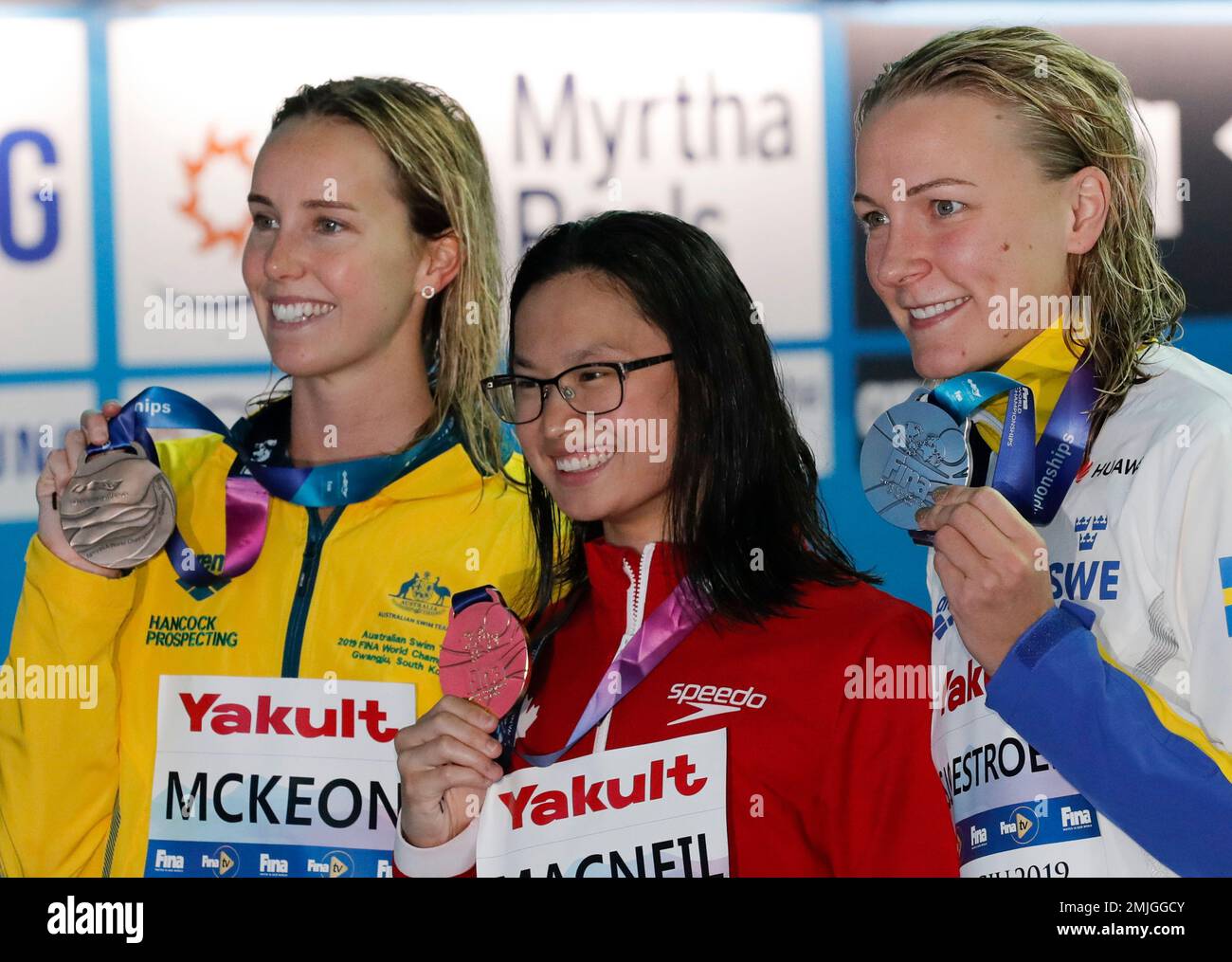 Gold medalist Canada's Margaret MacNeil, centre, stands with silver ...