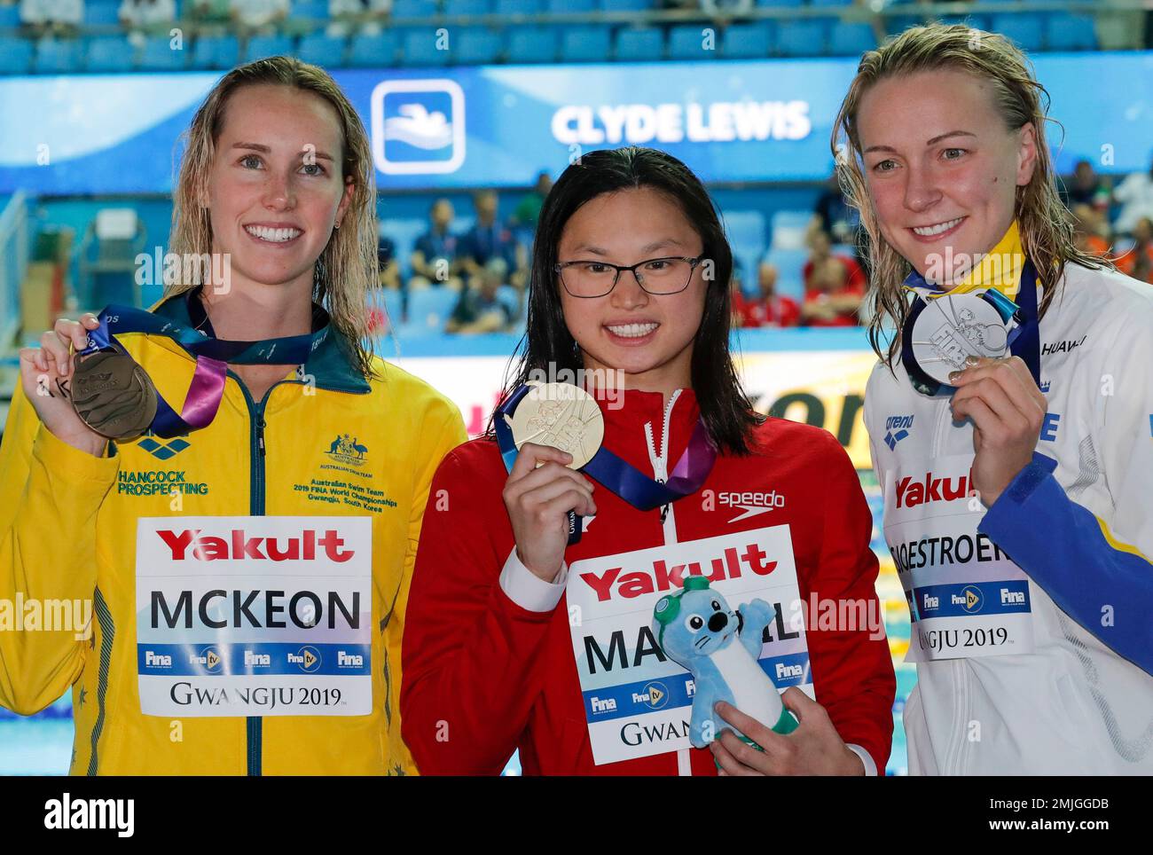 Gold medalist Canada's Margaret MacNeil, centre, stands with silver ...