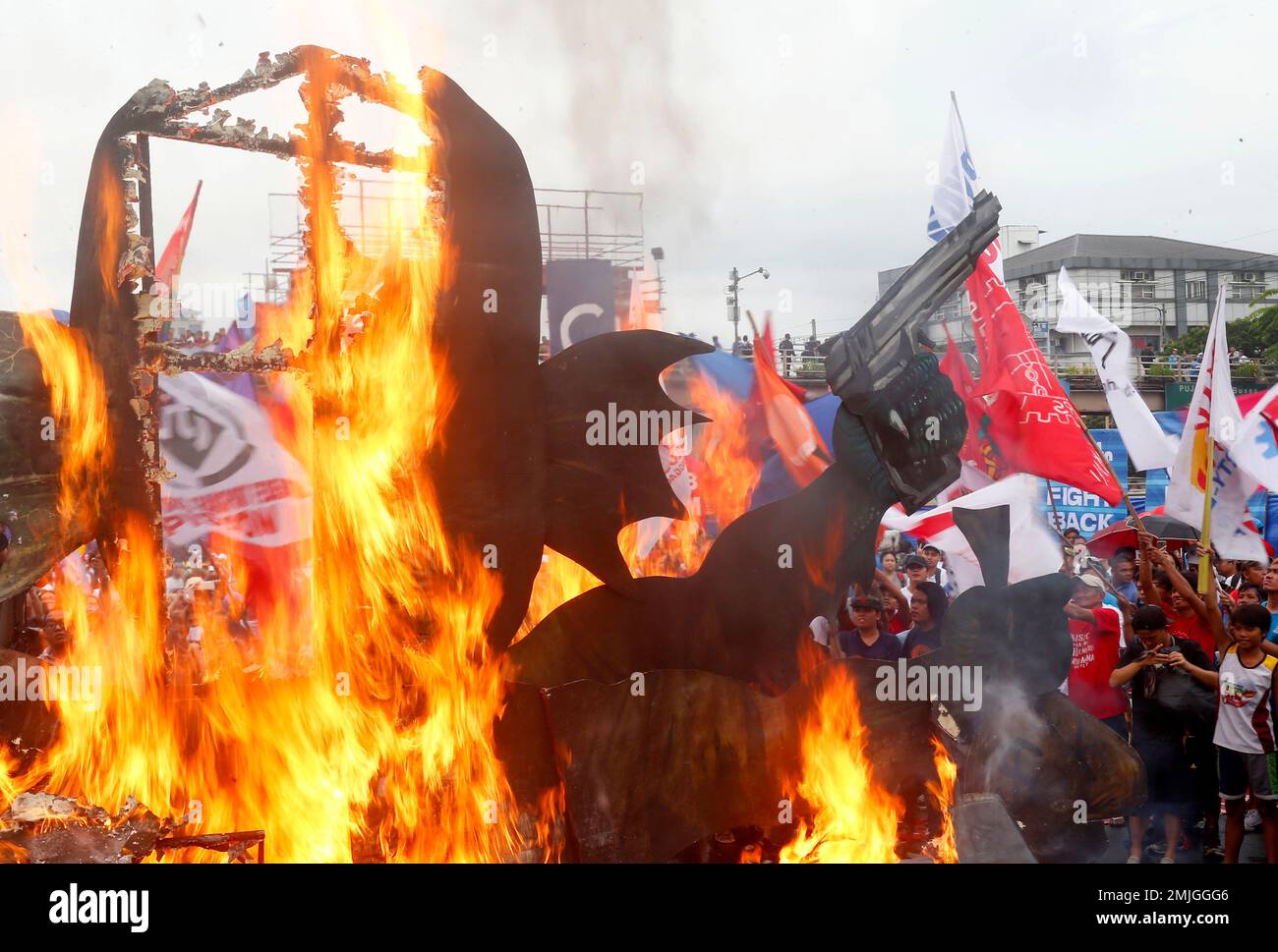 Protesters burn an effigy of President Rodrigo Duterte during a rally ...
