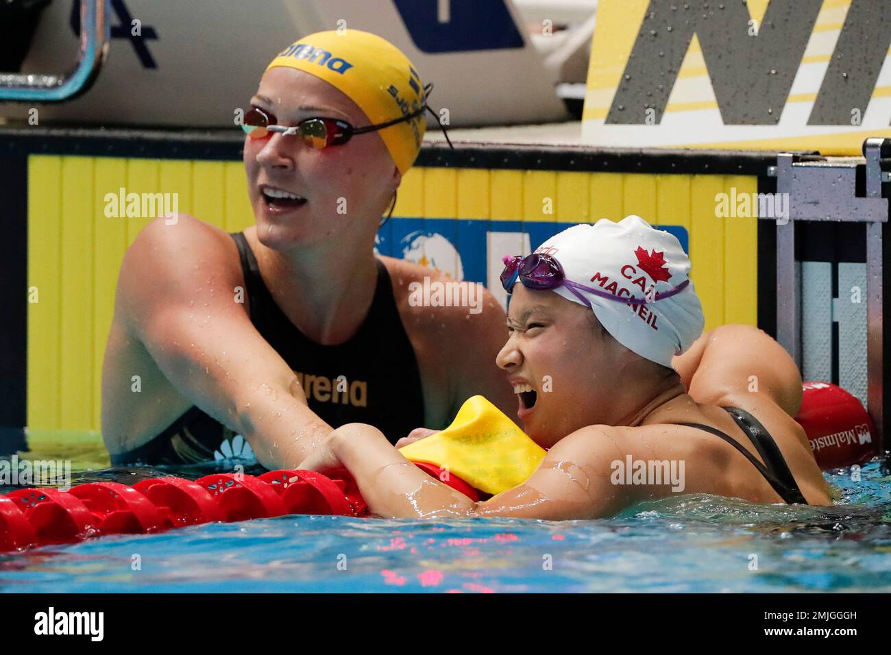 Canada's Margaret MacNeil, right, reacts with Sweden's Sarah Sjostrom ...