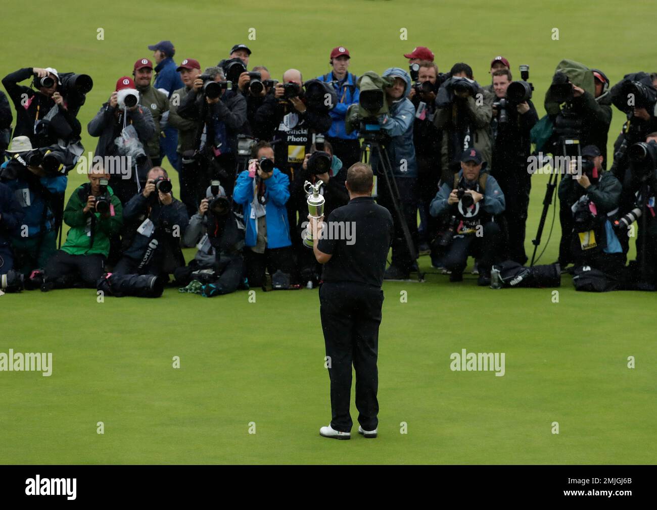 Ireland's Shane Lowry poses for the media holding up the Claret Jug ...