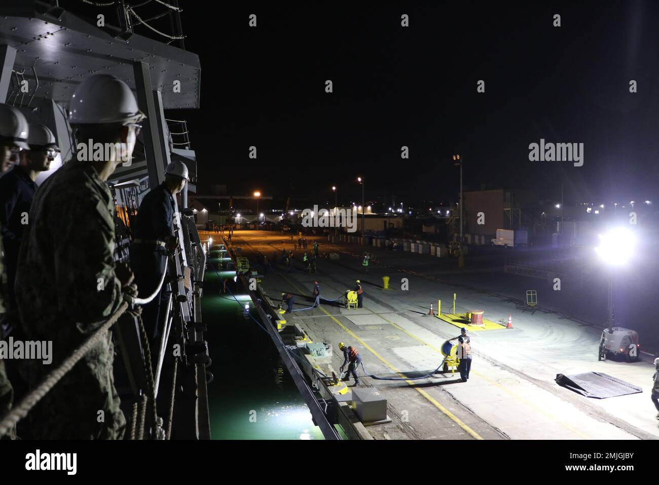Steelworkers of USS Stethem oversee the entrance into their ship into ...