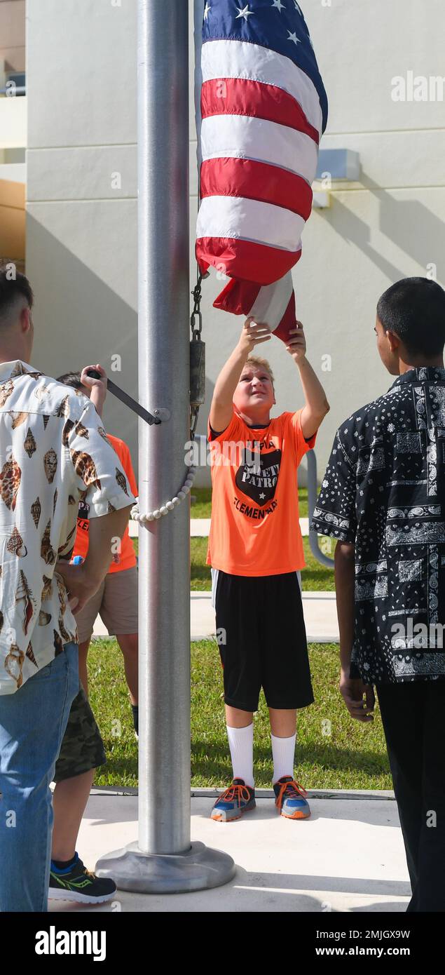 A Kadena Elementary School Safety Patrol student raises the American ...