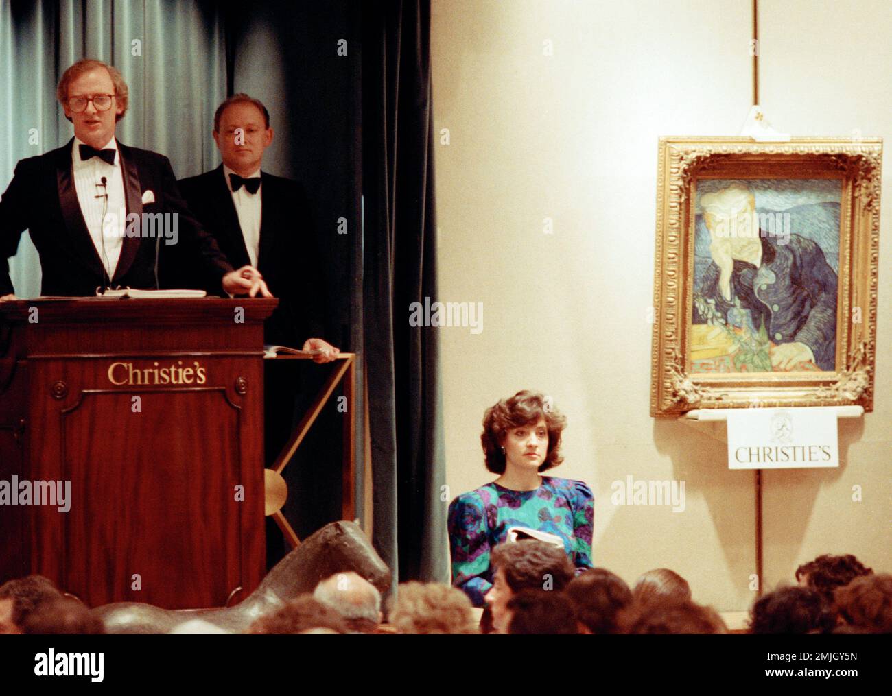 Auctioneer Christopher Burge, left, at podium, takes bids for Vincent ...