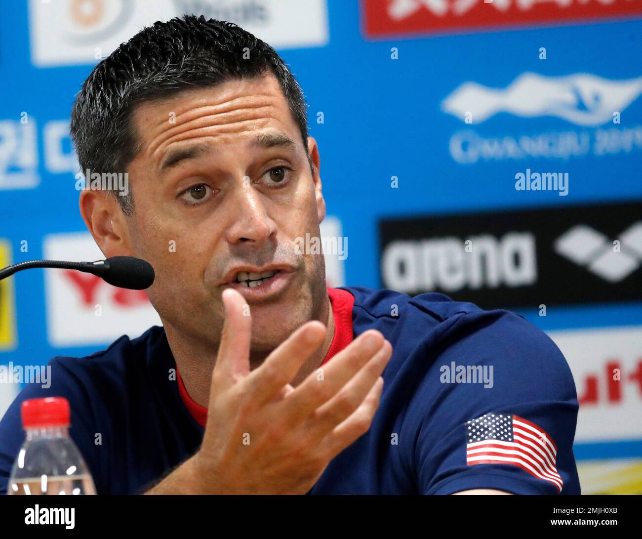 United States swim coach Greg Meehan gestures as he answers questions ...