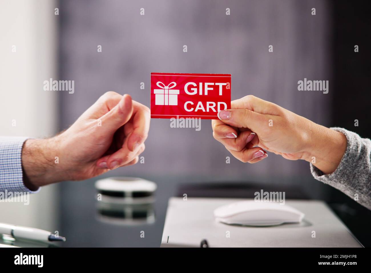 Hand Giving Gift Voucher Card. Holding Prepaid Coupon Stock Photo - Alamy