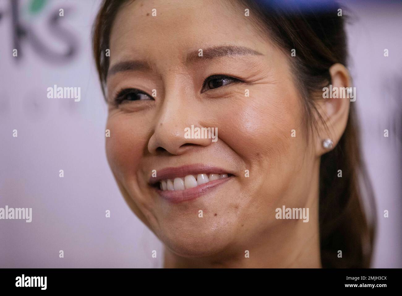 Two-time Grand Slam champion Li Na smiles while talking to the media at ...