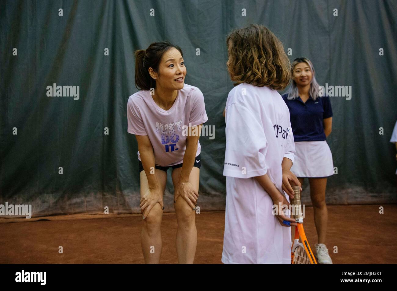Two-time Grand Slam champion Li Na talks to one of the students during ...