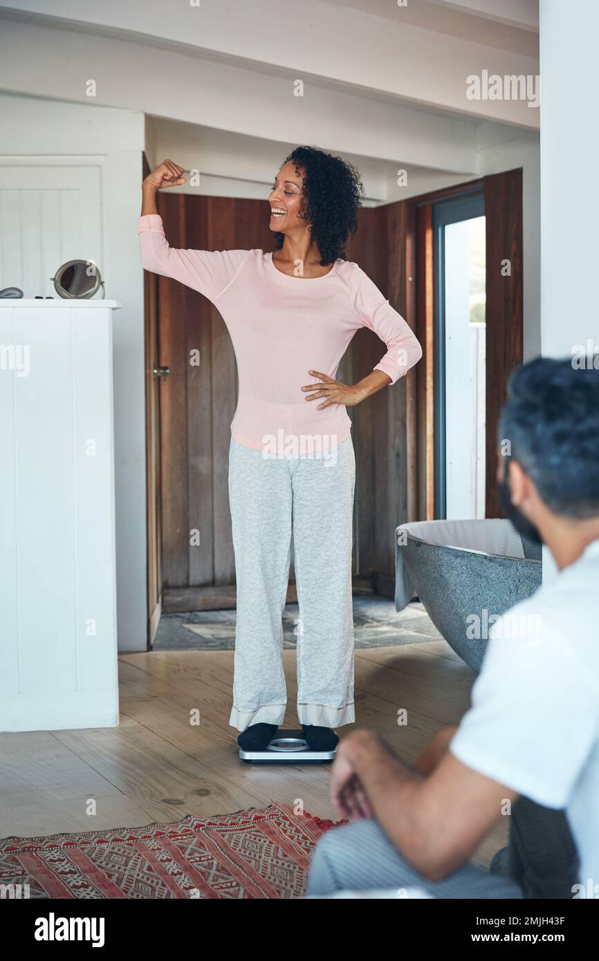 Feeling strong, feeling fit, feeling good. a mature woman weighing ...