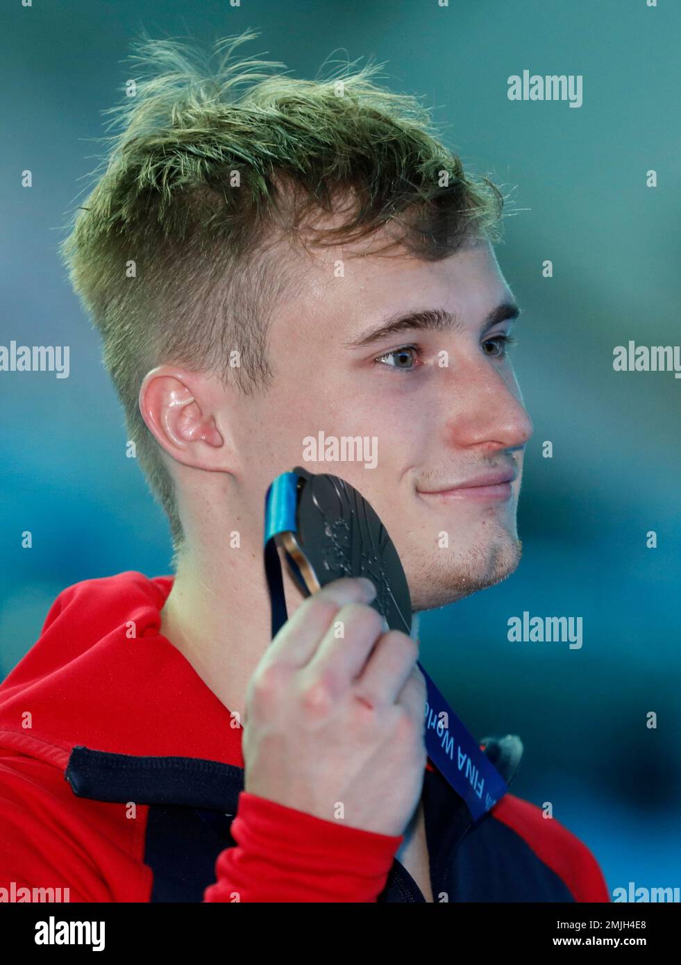 Britain's Jack Laugher holds up his bronze medal following the men's 3m ...