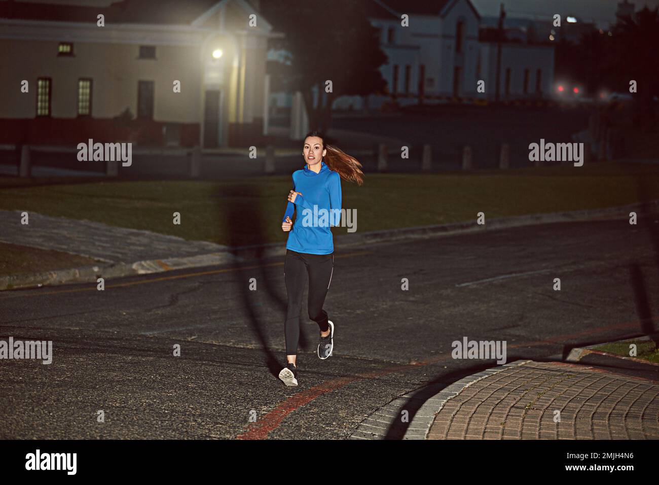 Never on time but always on pace. a young woman out running at night ...