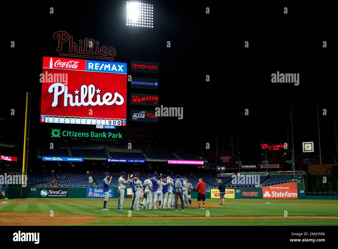 Los Angeles Dodgers players celebrate after a rain-delayed baseball ...