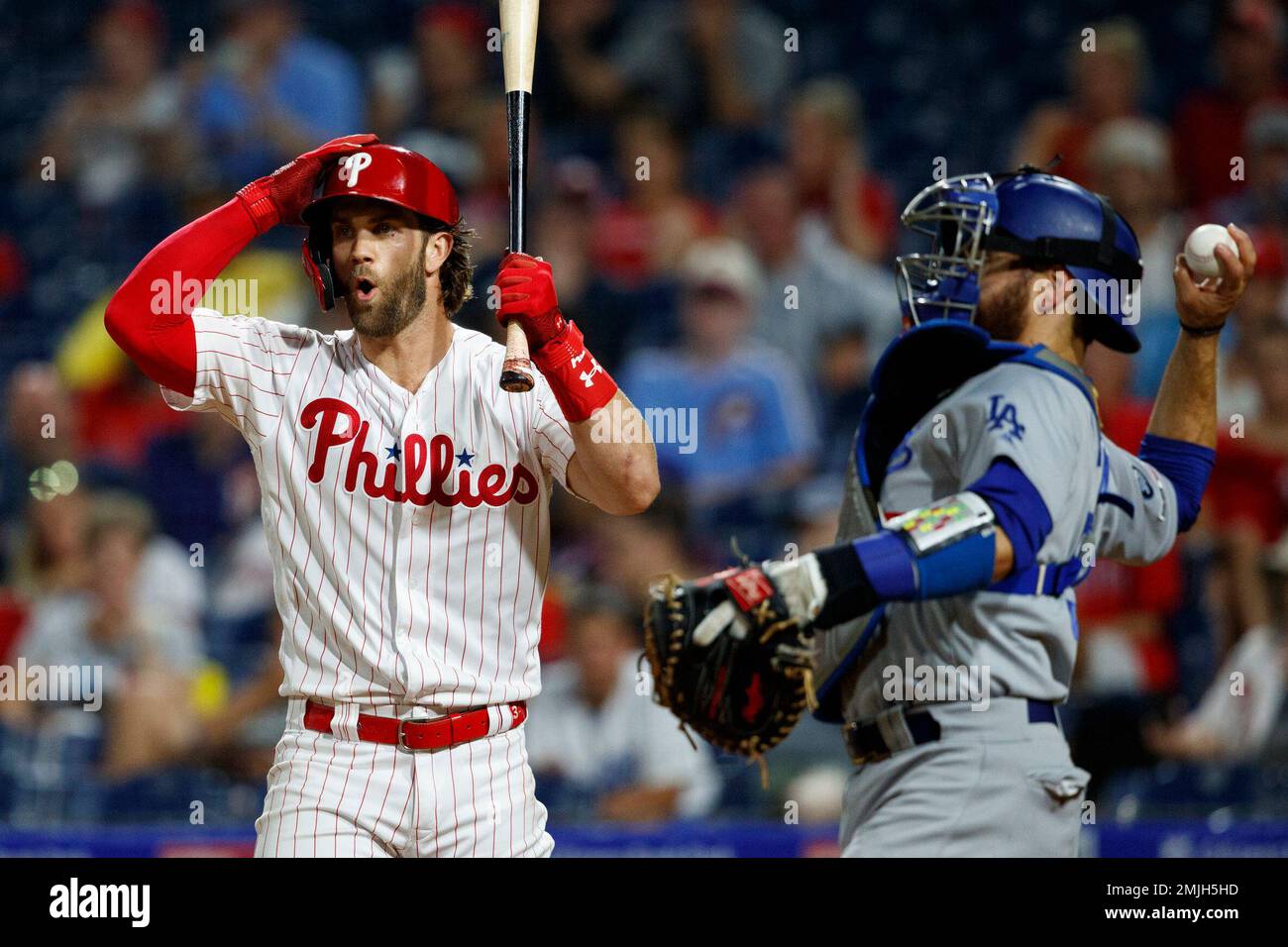 Philadelphia Phillies' Bryce Harper, left, reacts after striking out ...