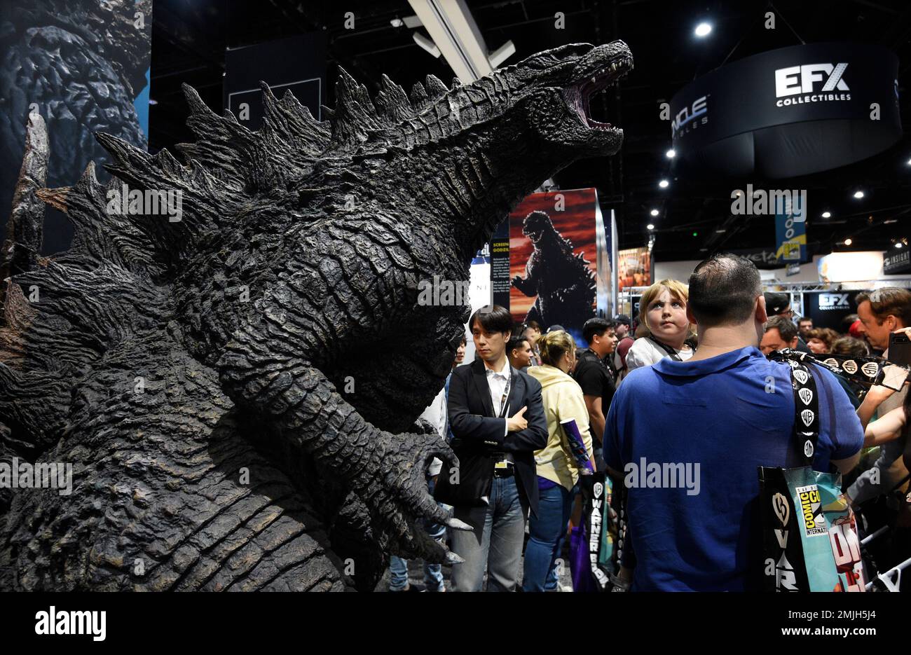 Marielle Larson, 3, looks over her father Derek's shoulder at an ...
