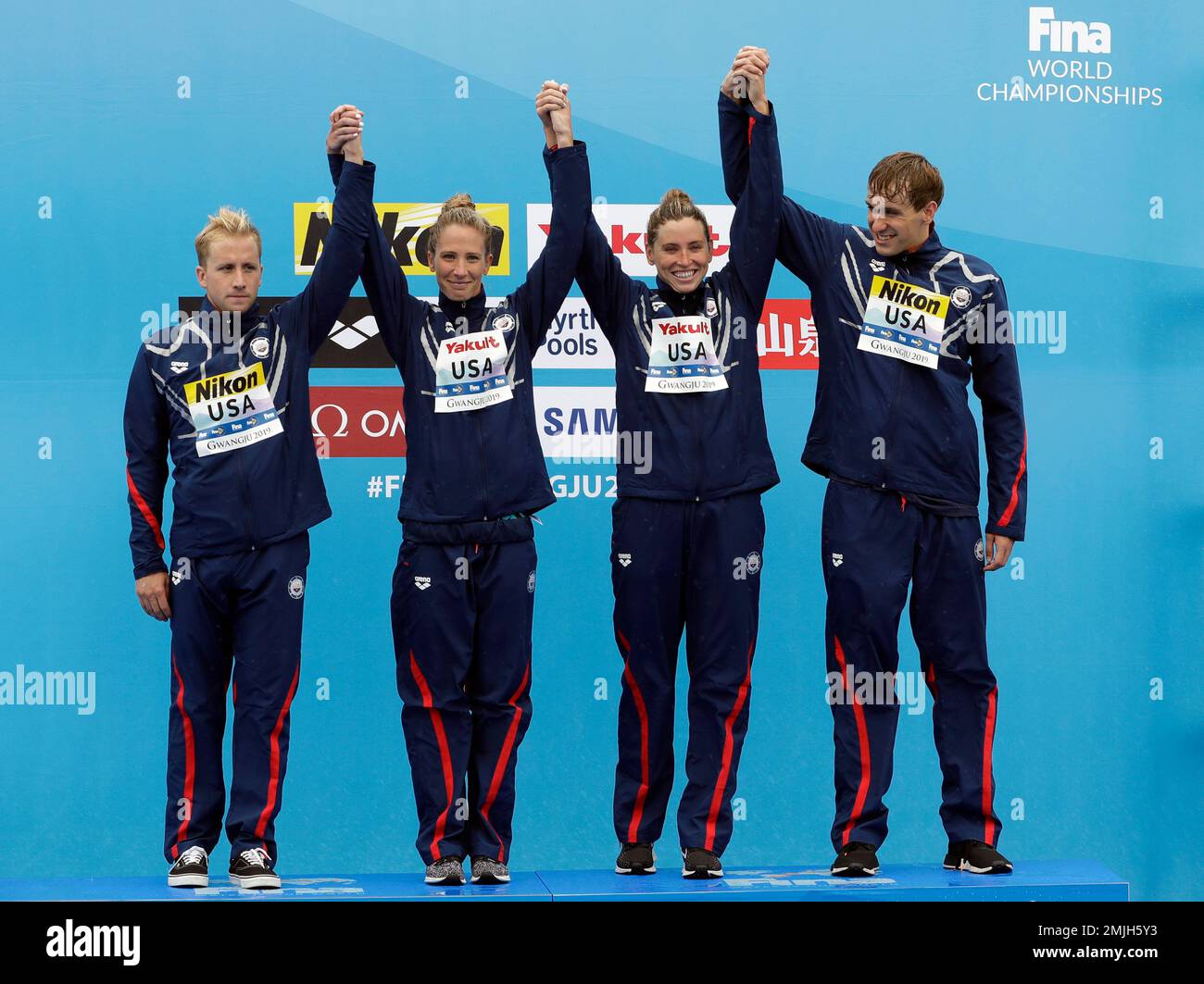 Members of the bronze medal-winning team from the United States stand ...