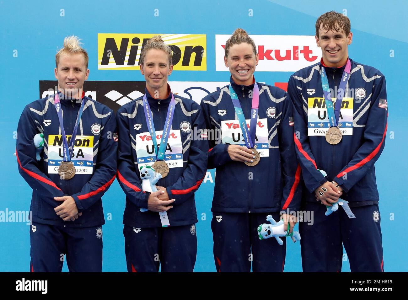 Members of the bronze medal-winning team from the United States stand ...