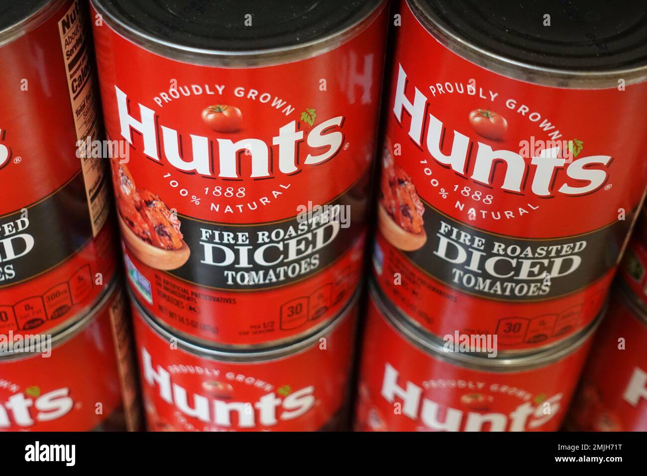 Canned tomato products by Hunt's, a Conagra brand, rest on a ...