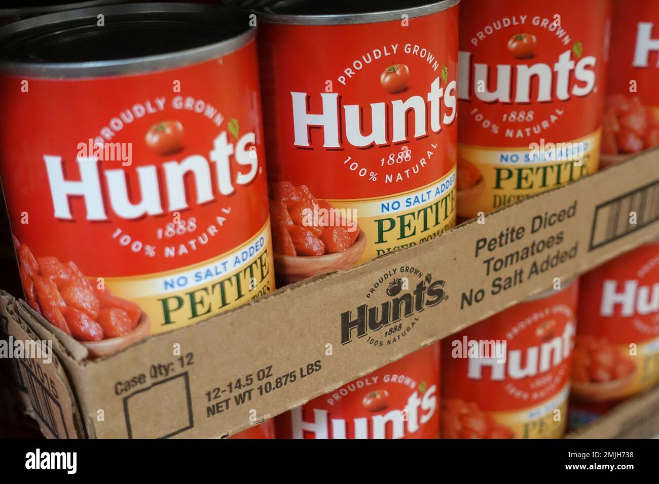 Canned tomato products by Hunt's, a Conagra brand, rest on a ...