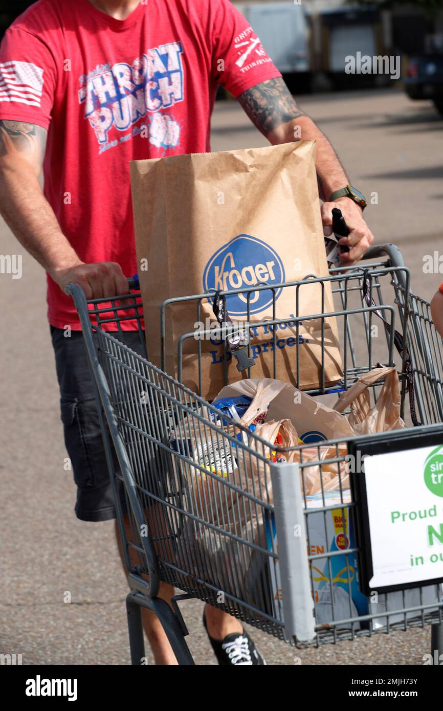 A customer exits a Kroger grocery store in Flowood, Miss., Wednesday ...