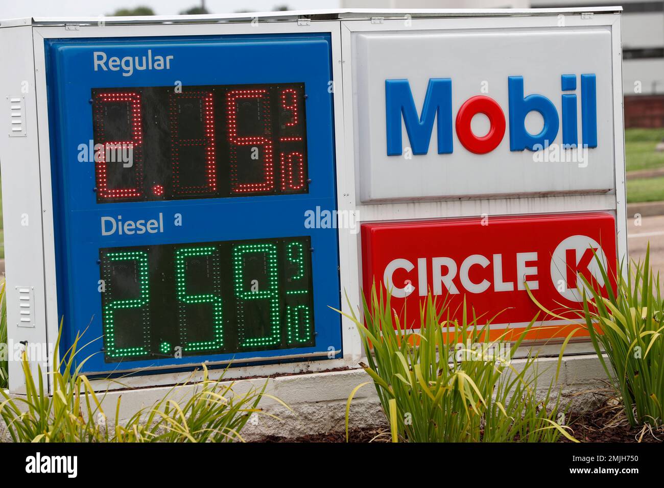 A Mobil convenience store sign displays its current gas prices in ...