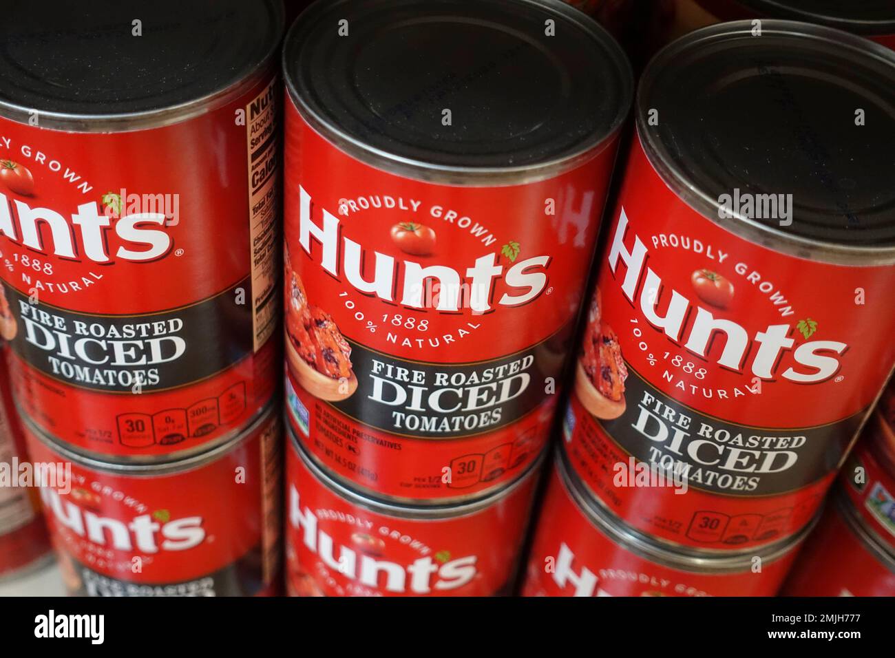 Canned tomato products by Hunt's, a Conagra brand, rest on a ...