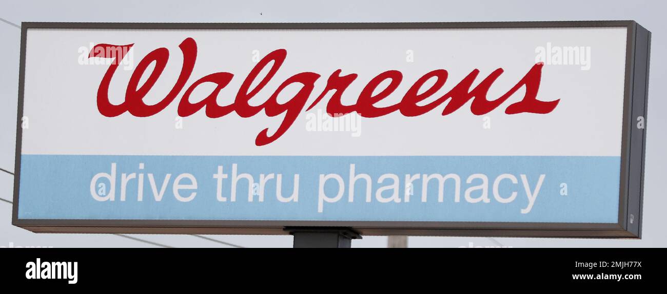 A Walgreens marquee highlights the drive thru service offered at one of ...