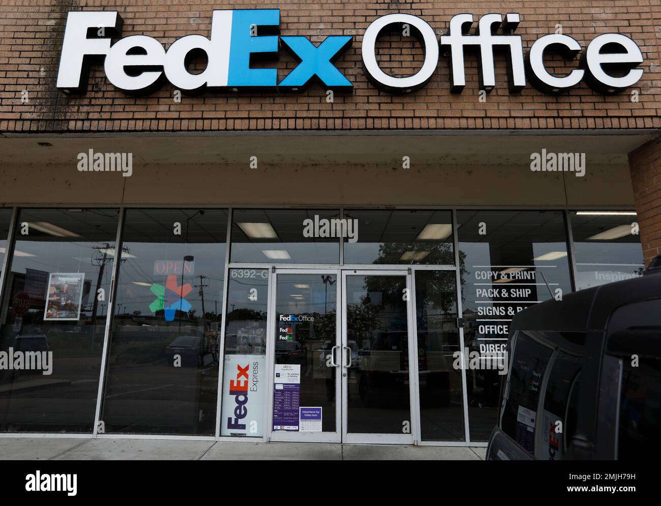 A FedEx Office overhead sign beacons customers to their multi service ...