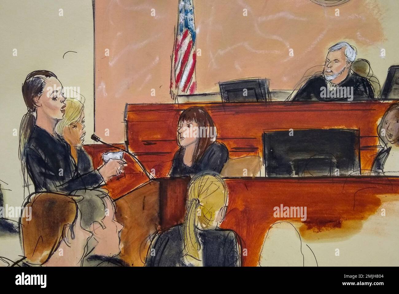 In this courtroom sketch, Andrea Velez Fernandez, far left, speaks via an interpreter during ...
