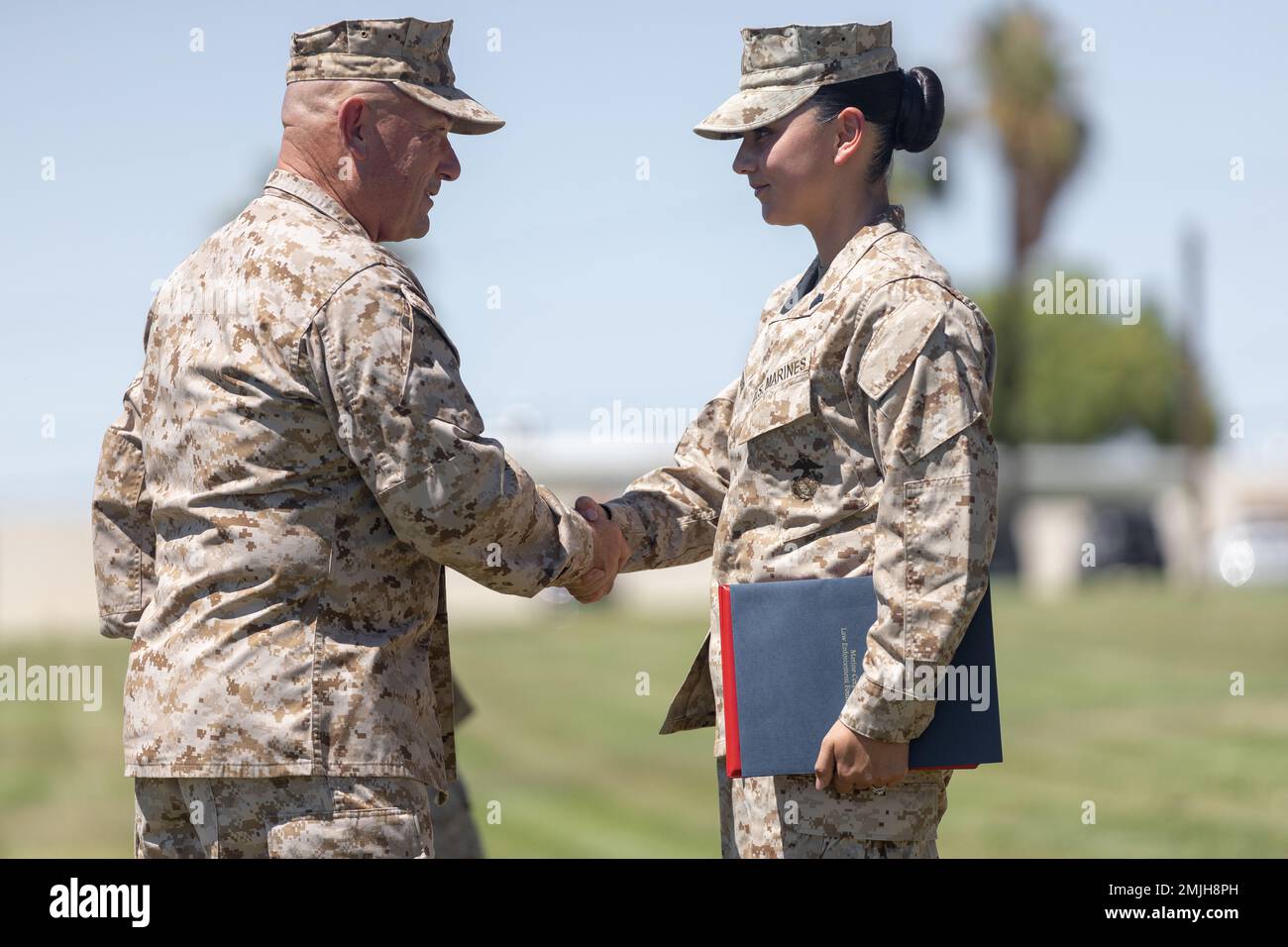 U.S. Marine Corps Sgt. Leilana TupuaRodriguez, right, receives a ...