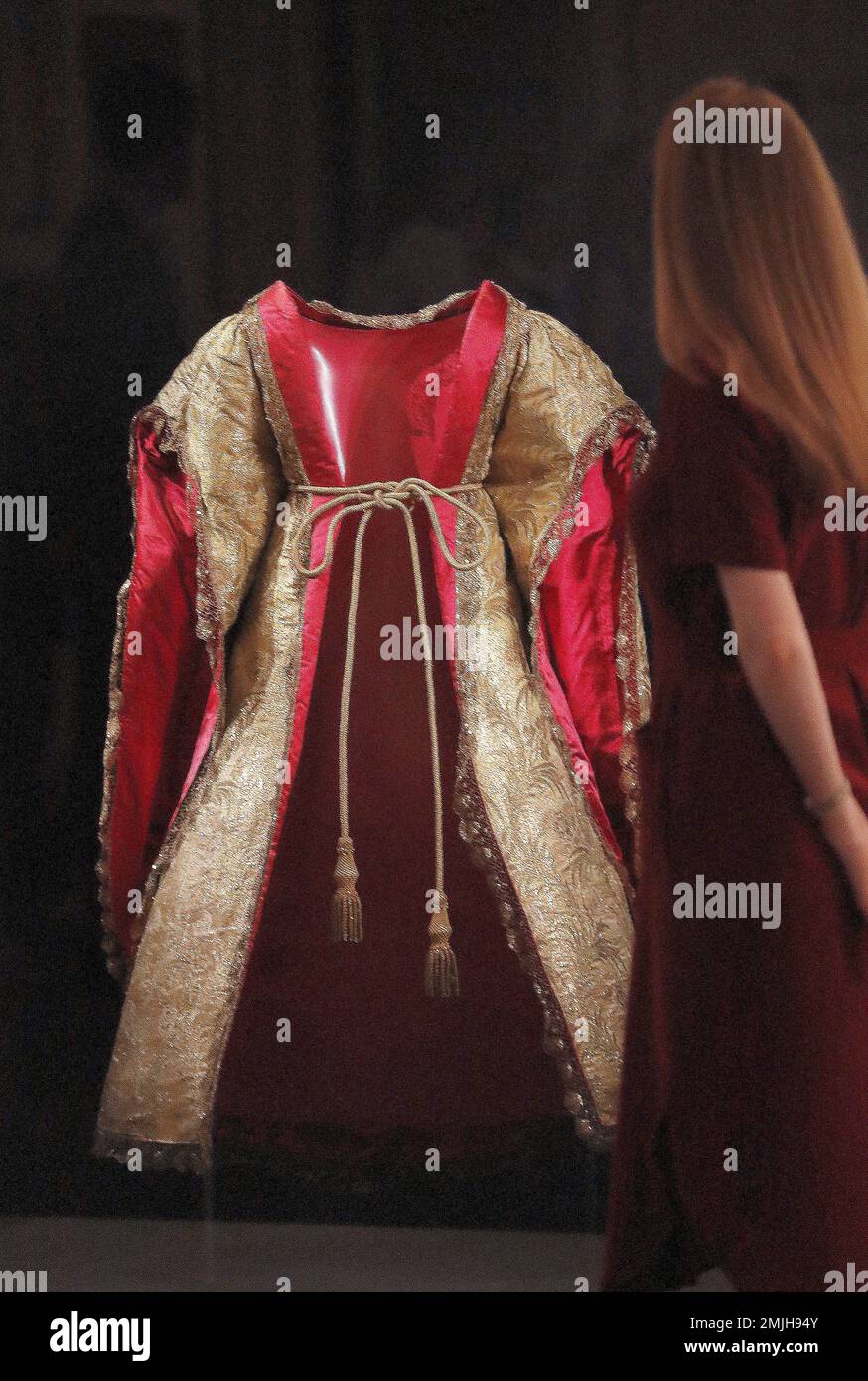 A woman looks at the Supertunica, a ceremonial gown worn by Britain's ...